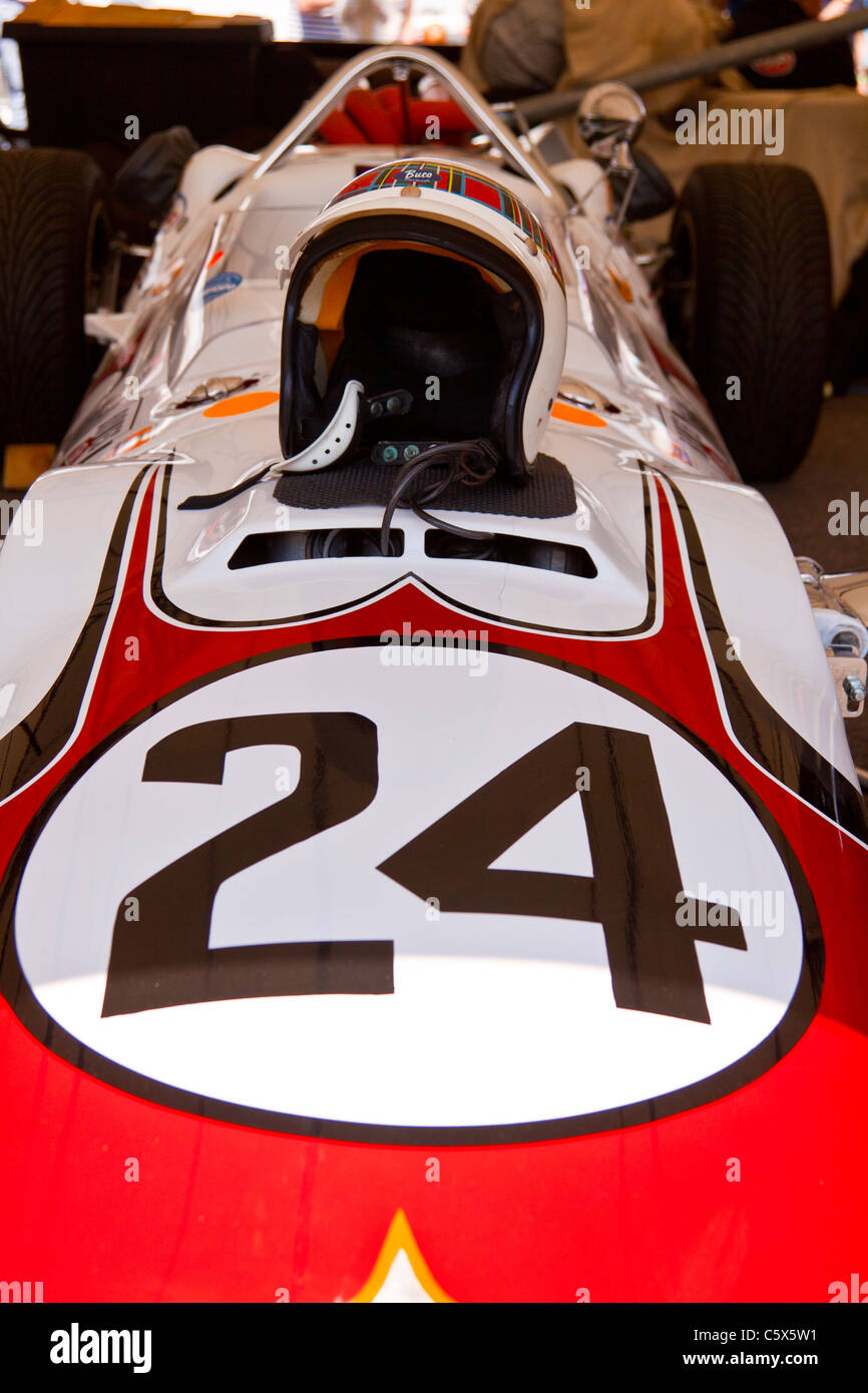 Red and white racing car number 24 with a white crash helmet on the ...