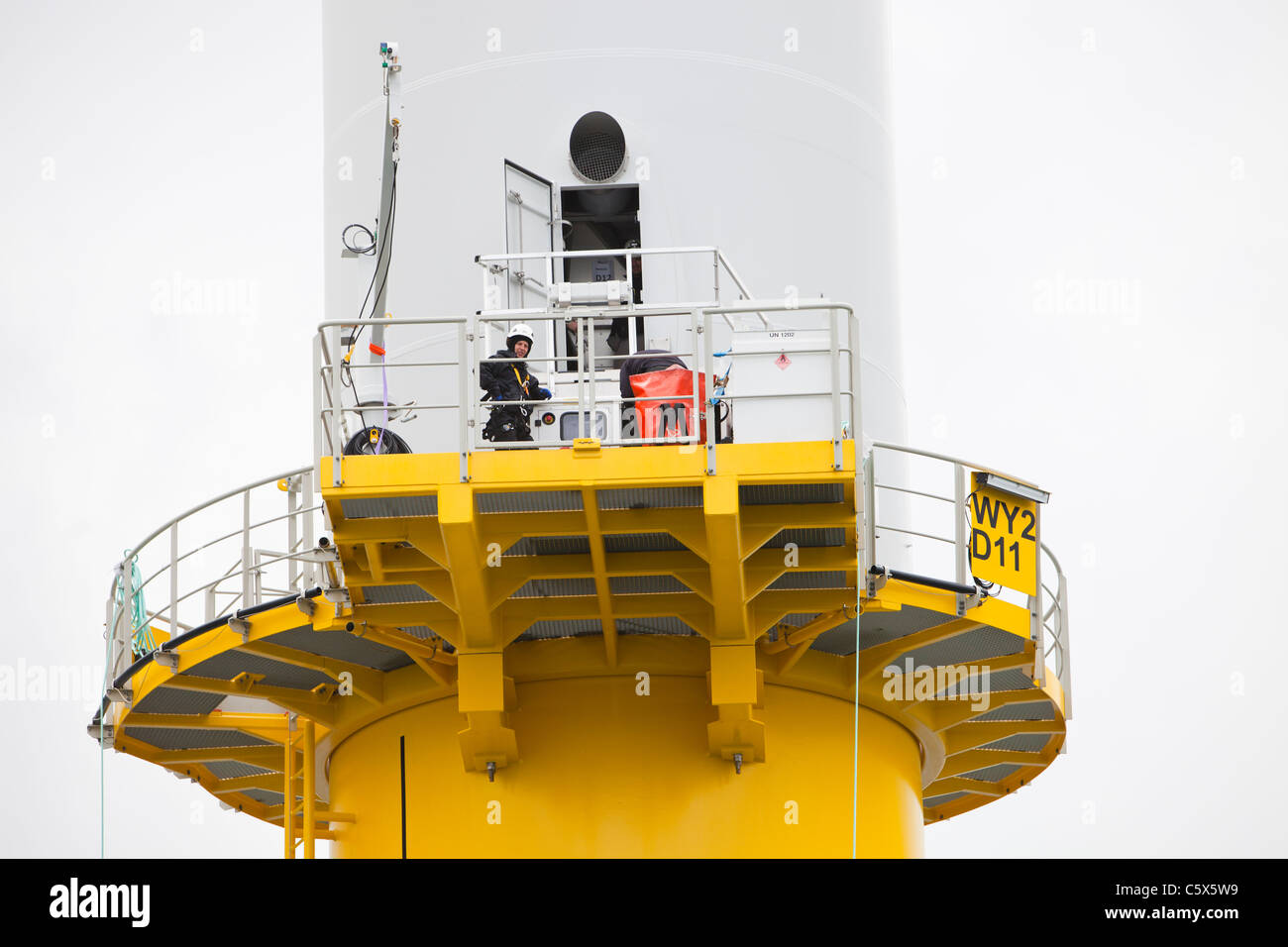 Offshore workers working on a wind turbine at the Walney Offshore ...
