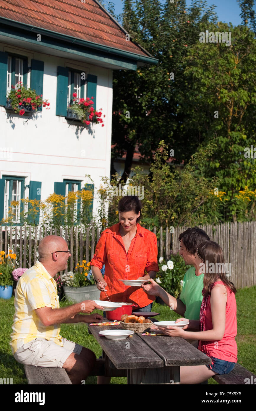 Germany, Bavaria, Friends eating in the garden Stock Photo - Alamy