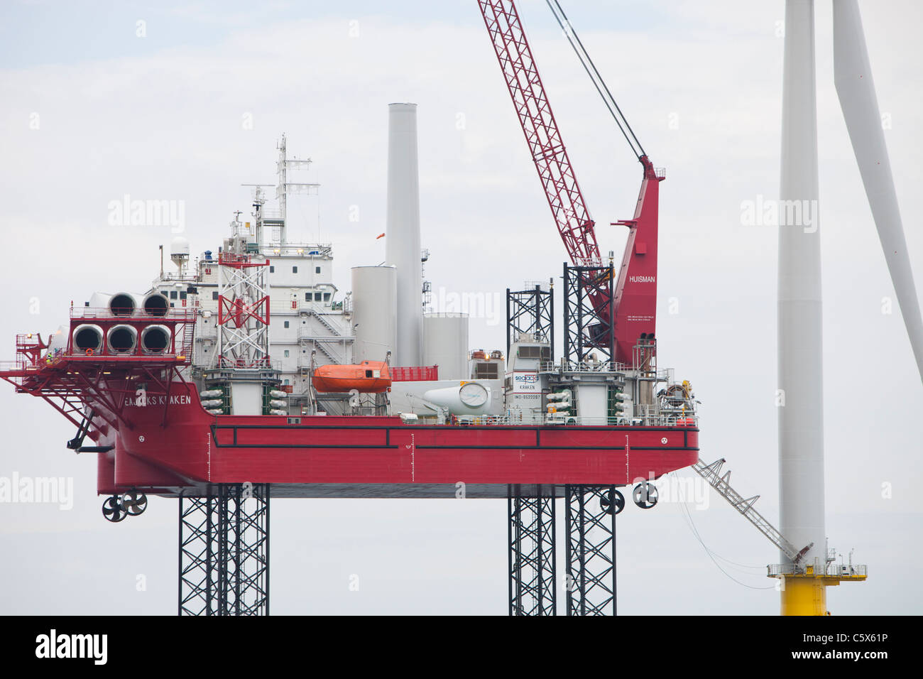 A jack up barge fitting wind turbines in the Walney Offshore windfarm ...