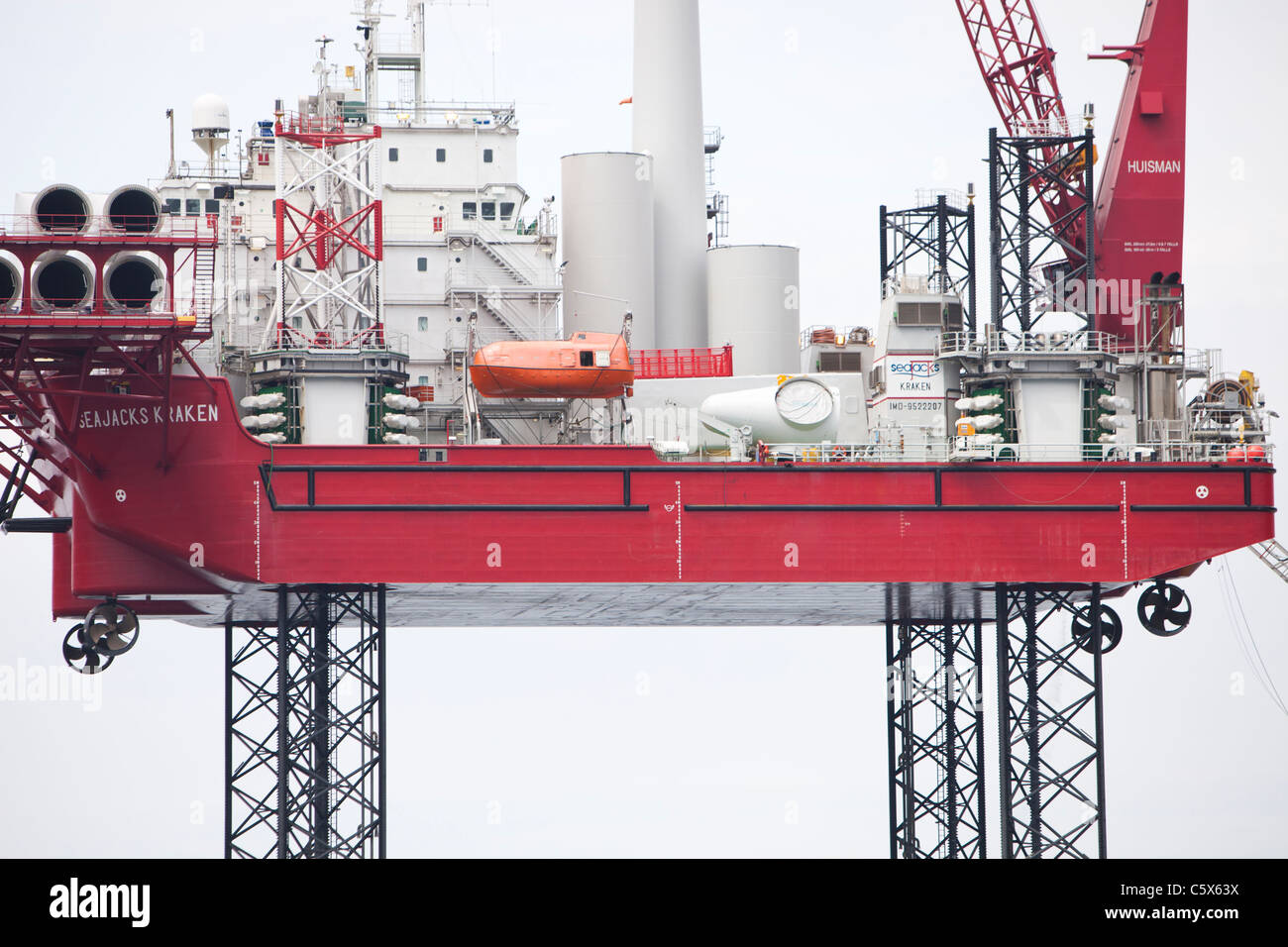 A jack up barge fitting wind turbines in the Walney Offshore windfarm ...