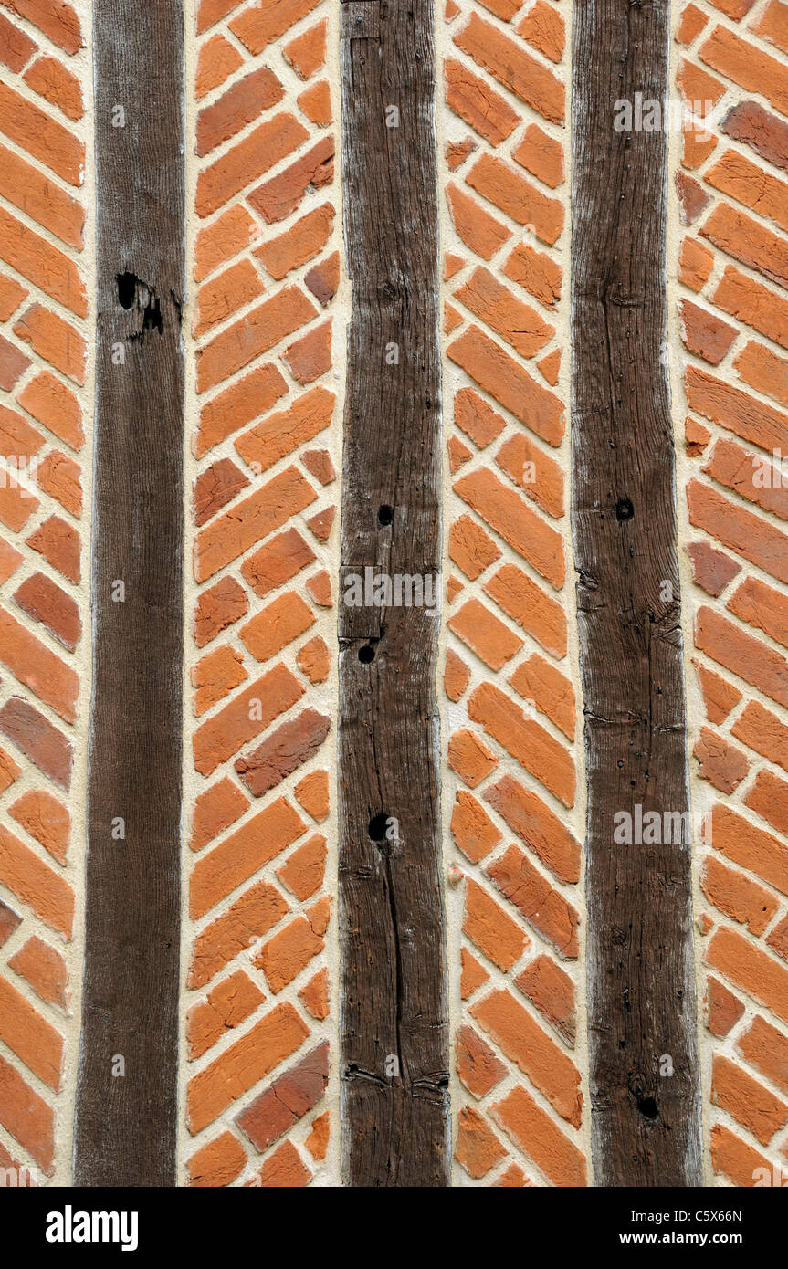 Exposed timber frame with red herringbone brick on the side of a 16th C ...