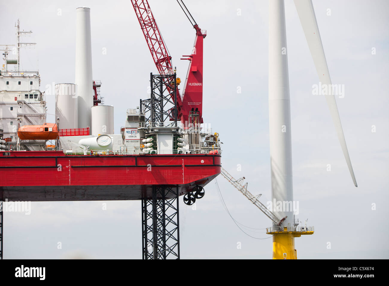 A jack up barge fitting wind turbines in the Walney Offshore windfarm ...
