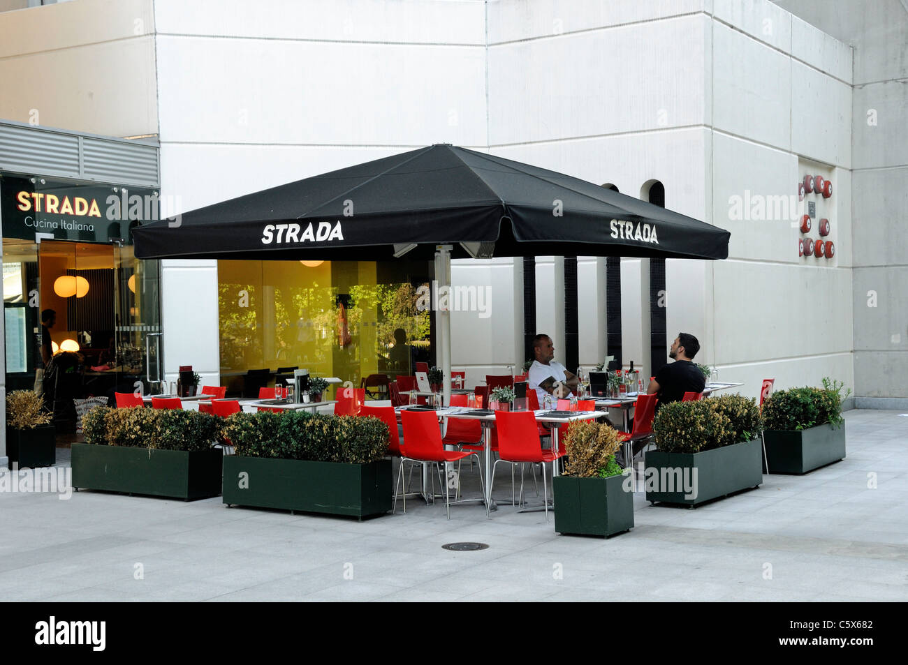 Two men at a table outside Strada resturant in the Branswick Centre ...