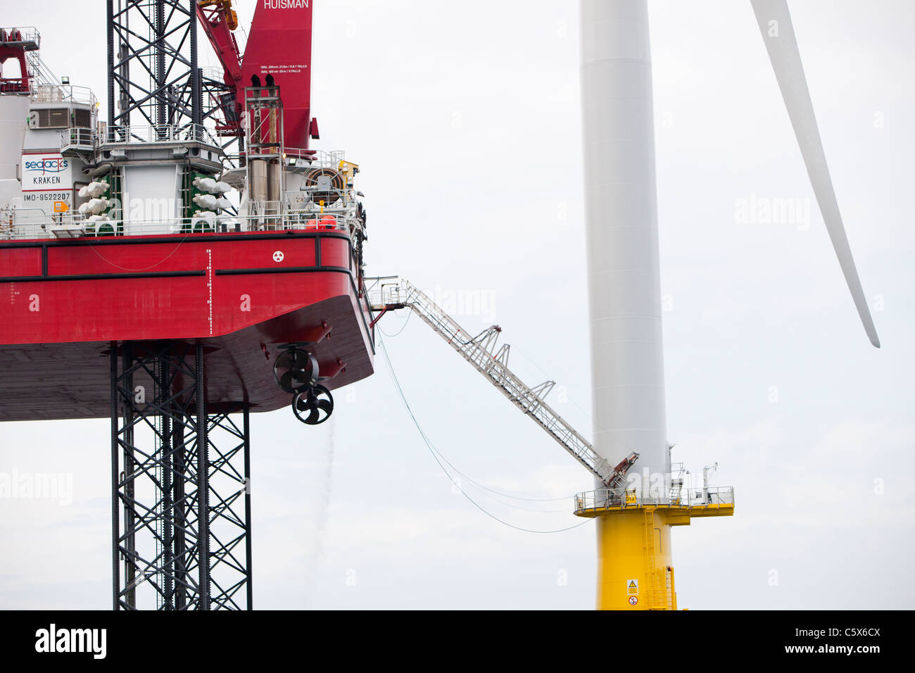 A jack up barge fitting wind turbines in the Walney Offshore windfarm ...