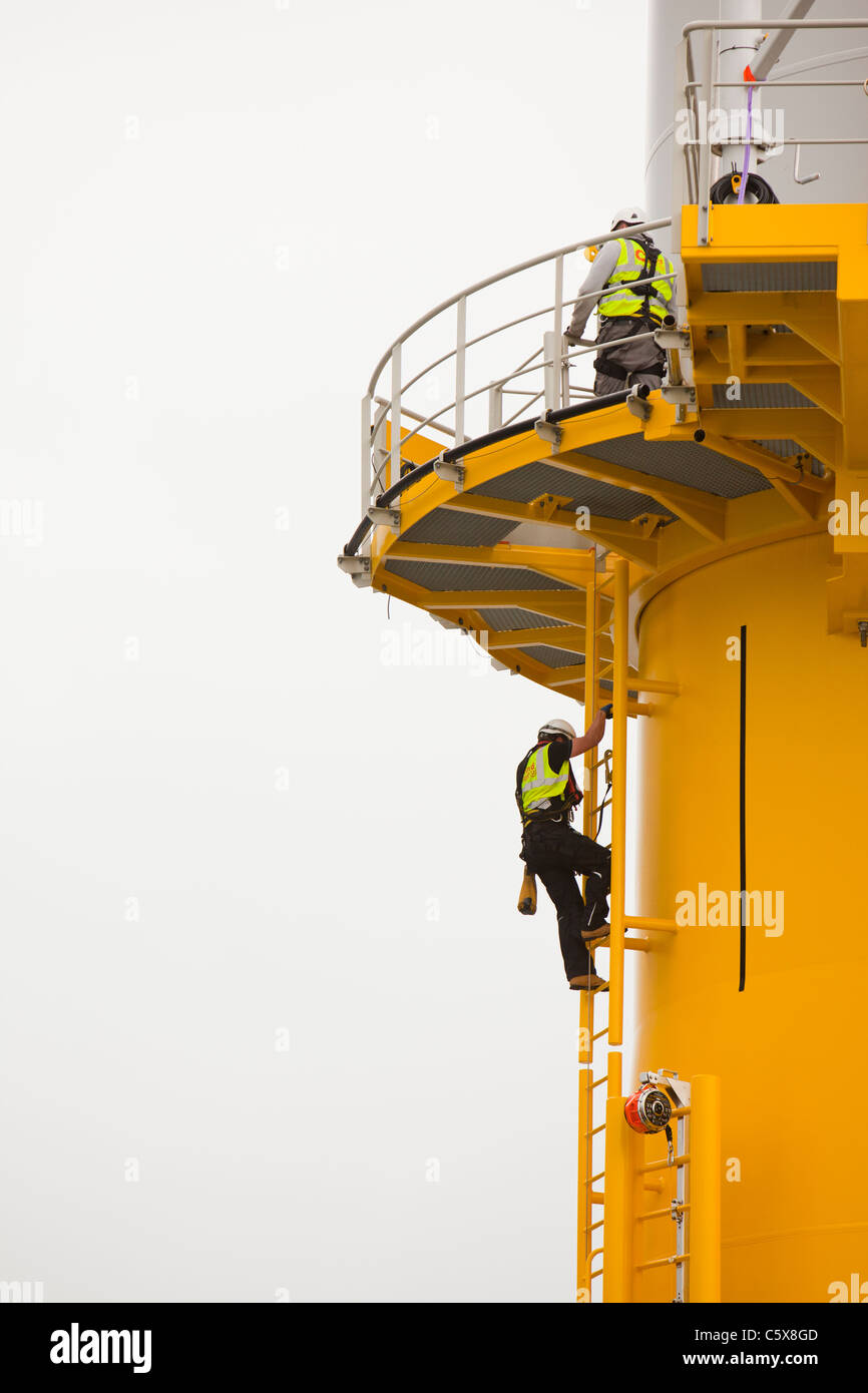 Offshore workers working on a wind turbine at the Walney Offshore ...
