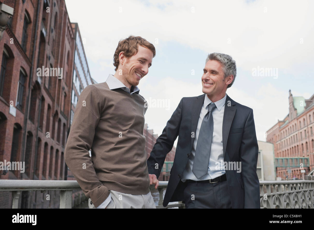 Germany, Hamburg, Two businessmen talking Stock Photo - Alamy