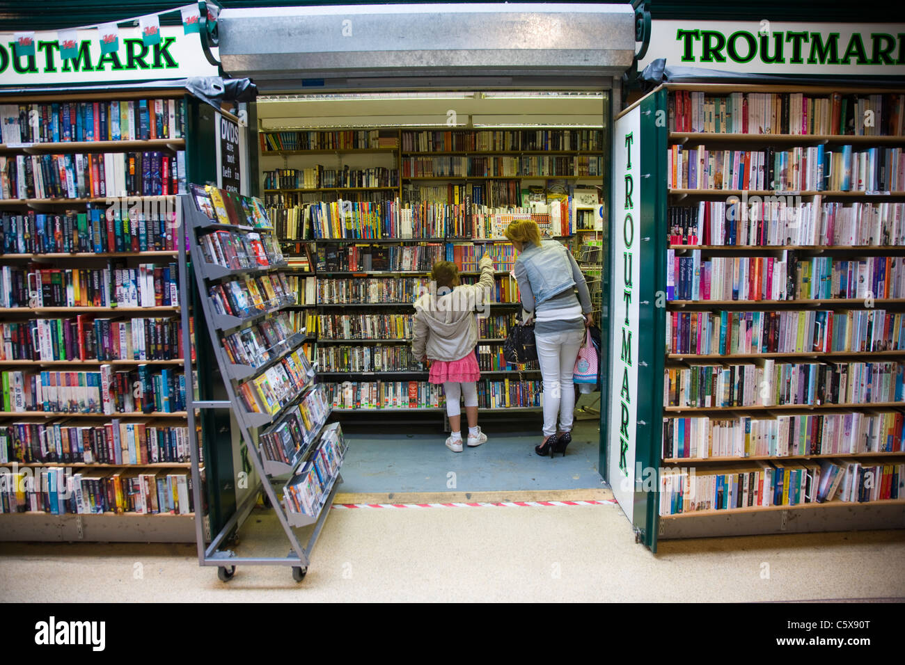 Browsing the shelves of a market bookshop in Newport, South Wales Stock ...