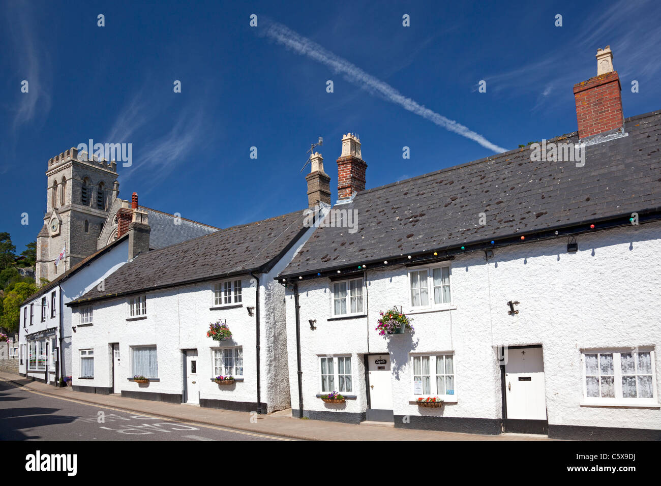 St Michael's Church alongside whitewashed houses, Beer, Devon Stock ...