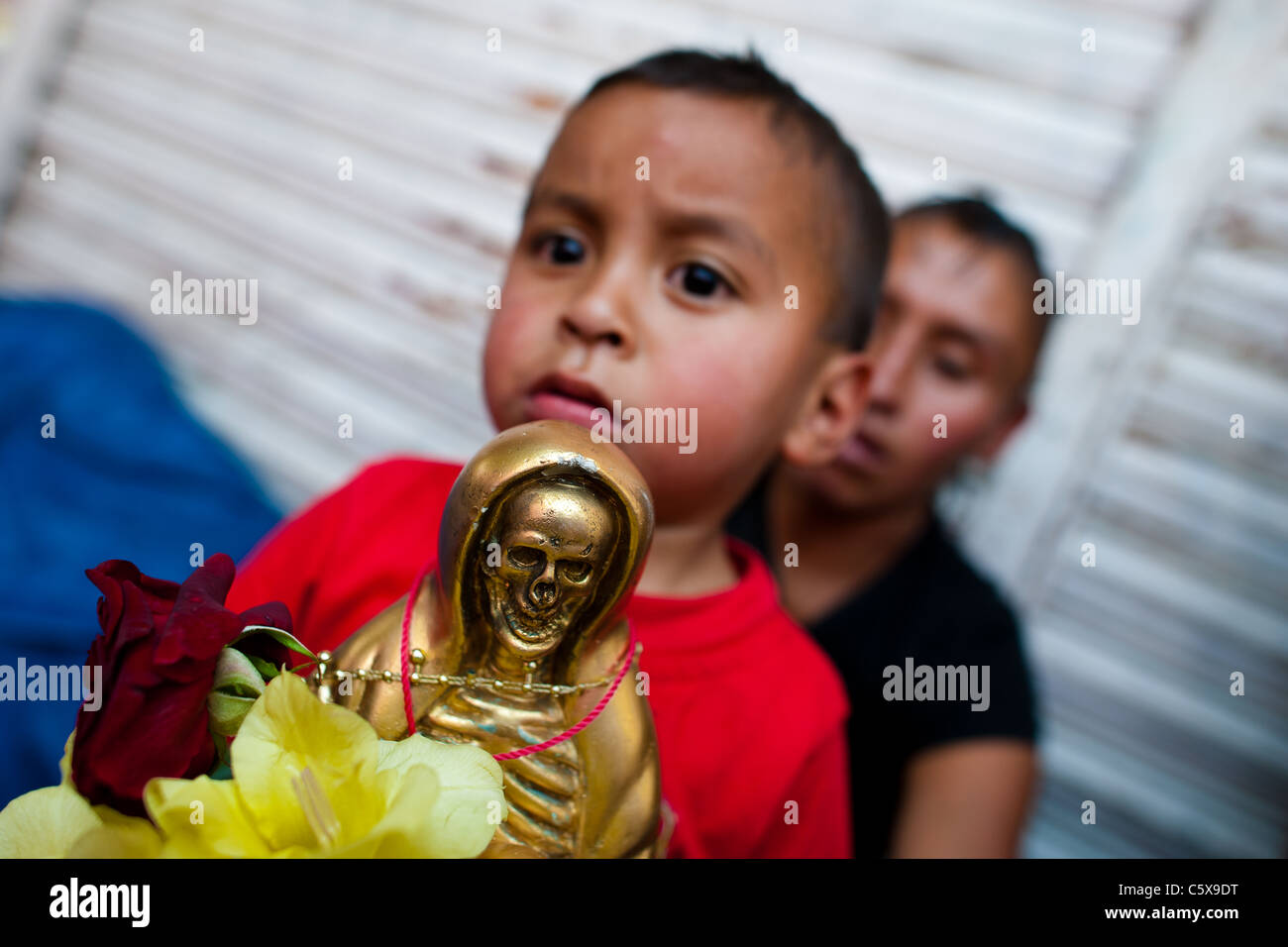 A Mexican devotee holds a figurine of Santa Muerte (Saint Death ...