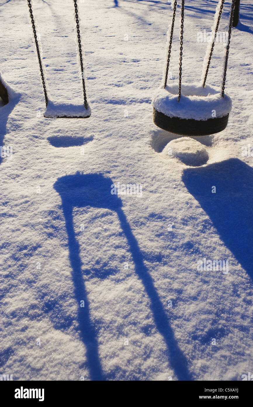 Children's playground, Snow-covered swing Stock Photo - Alamy