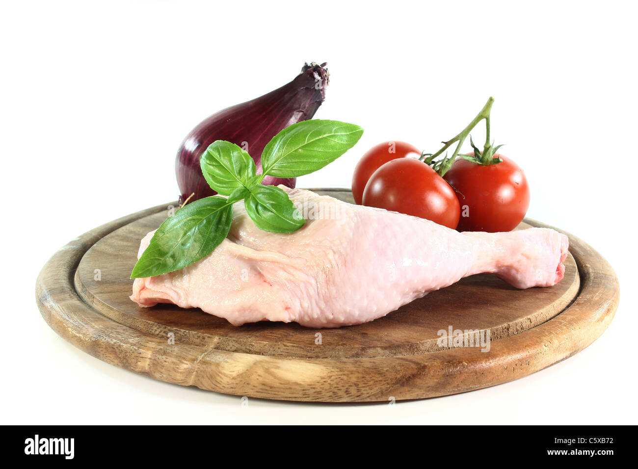 a raw chicken leg in front of white background Stock Photo - Alamy