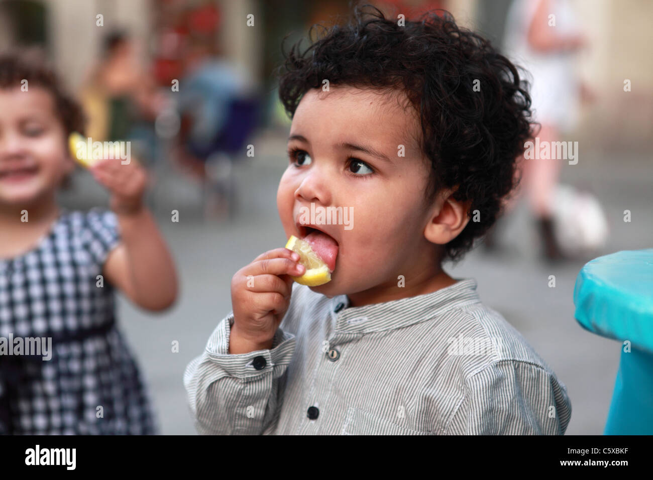 Boy Child Licking a Lemon Stock Photo - Alamy
