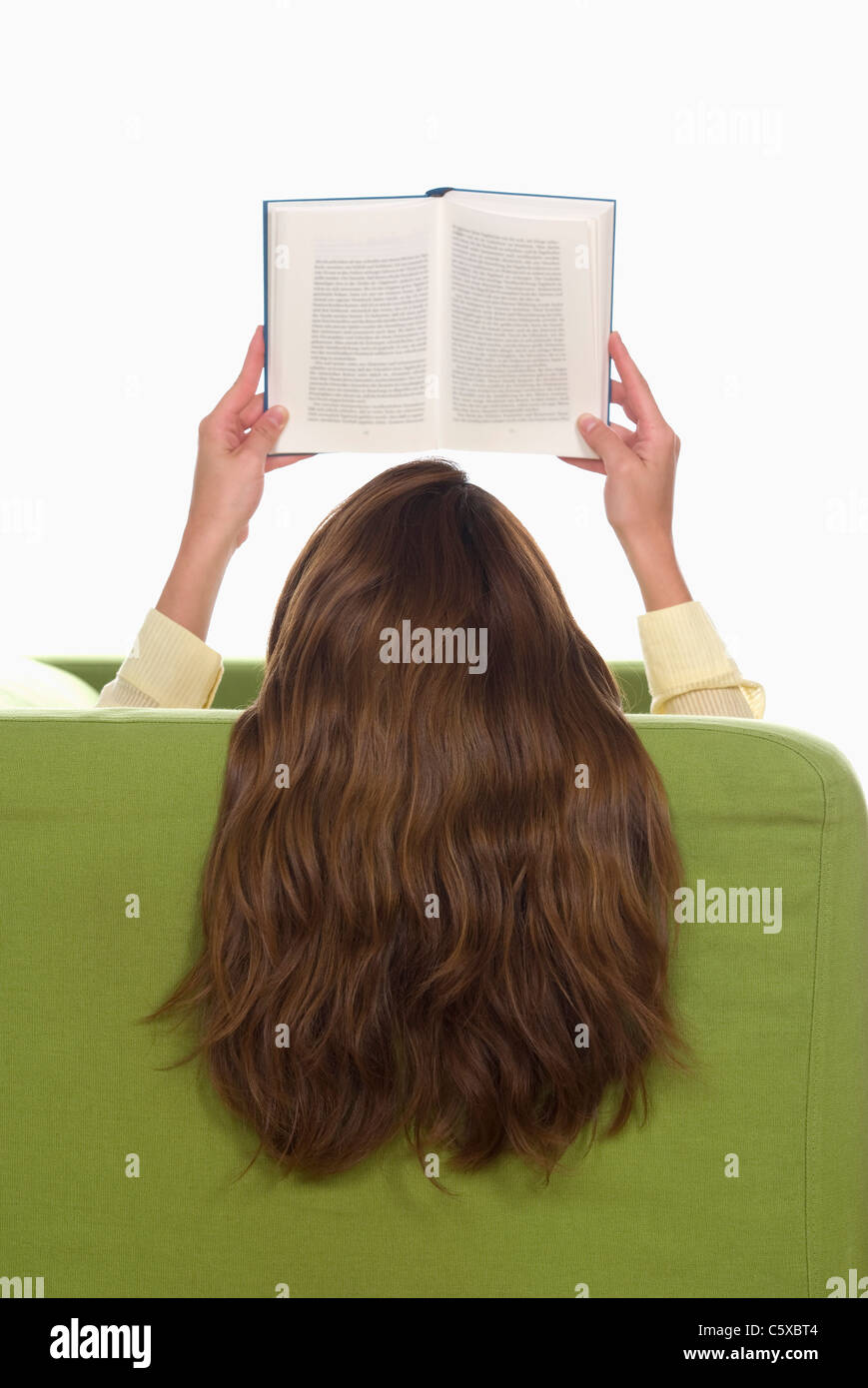 Woman reading book, rear view Stock Photo - Alamy