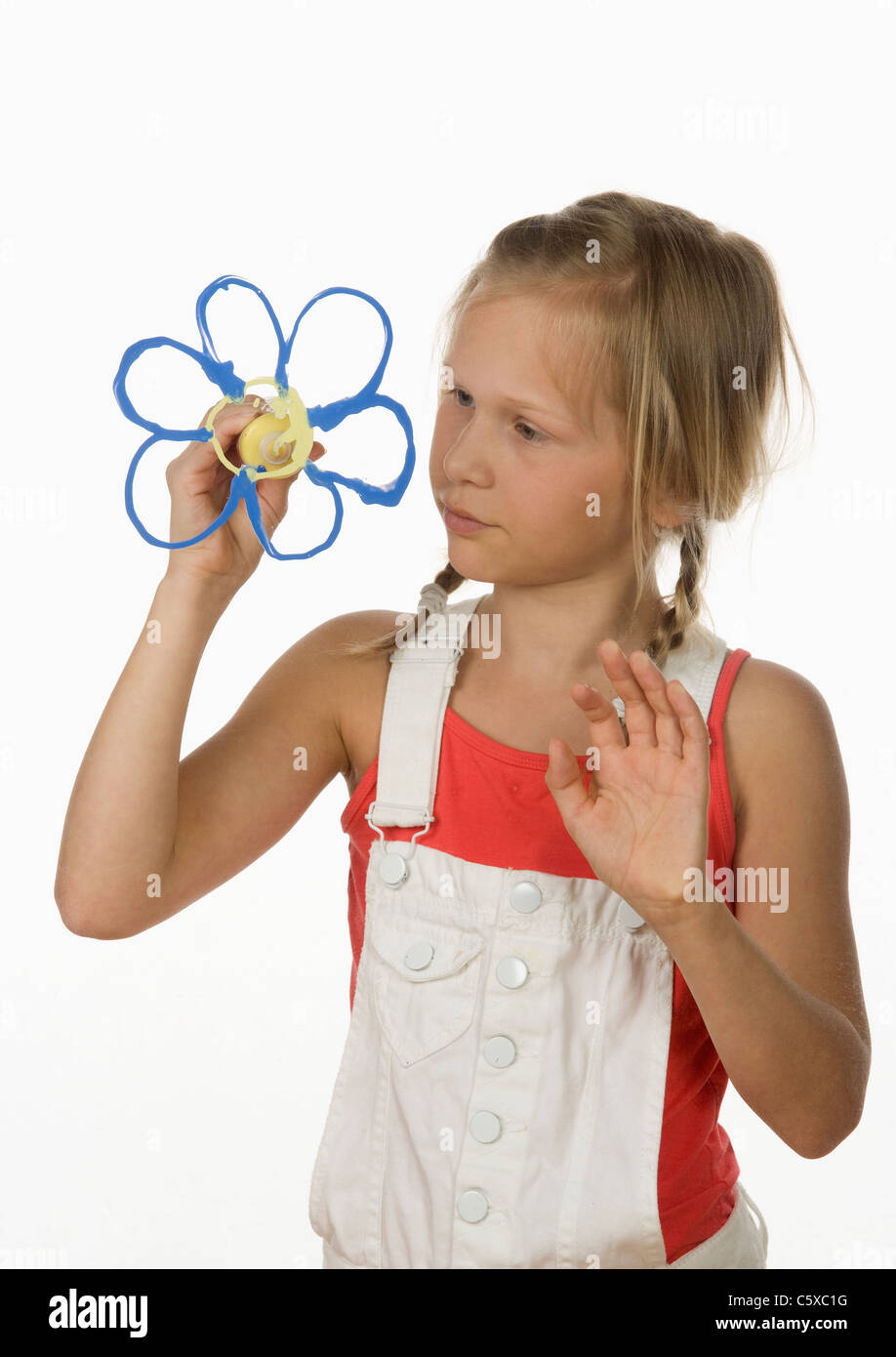 Girl (10-11) painting flower with fingerpaint, portrait Stock Photo - Alamy