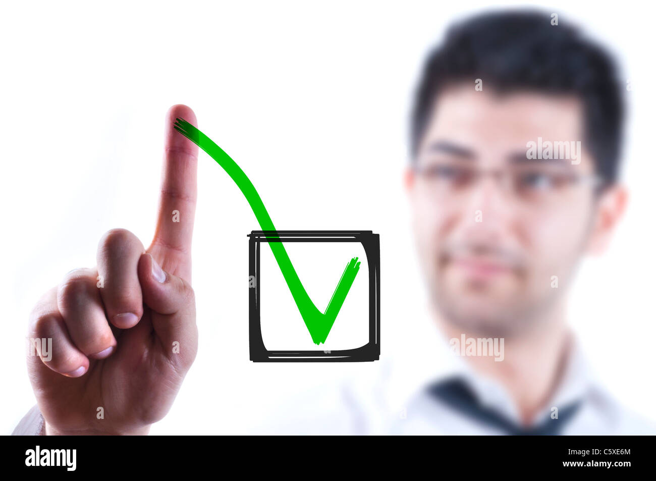 Young business man drawing a tick in a box on a glass board Stock Photo ...