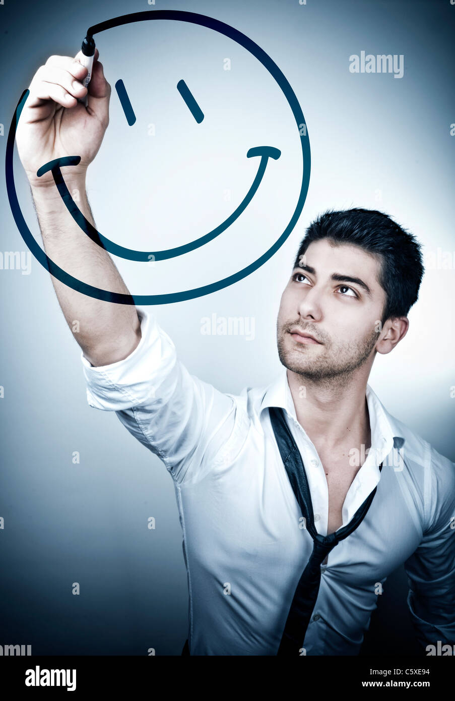 Young business man drawing a profit chart on a glass board Stock Photo ...