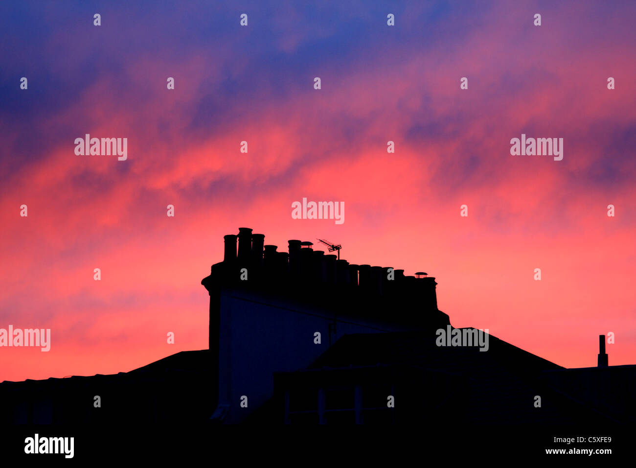 Sunset over rooftop Stock Photo - Alamy