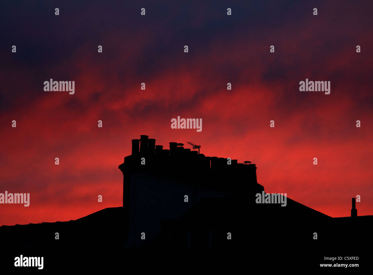 Sunset over rooftop Stock Photo - Alamy