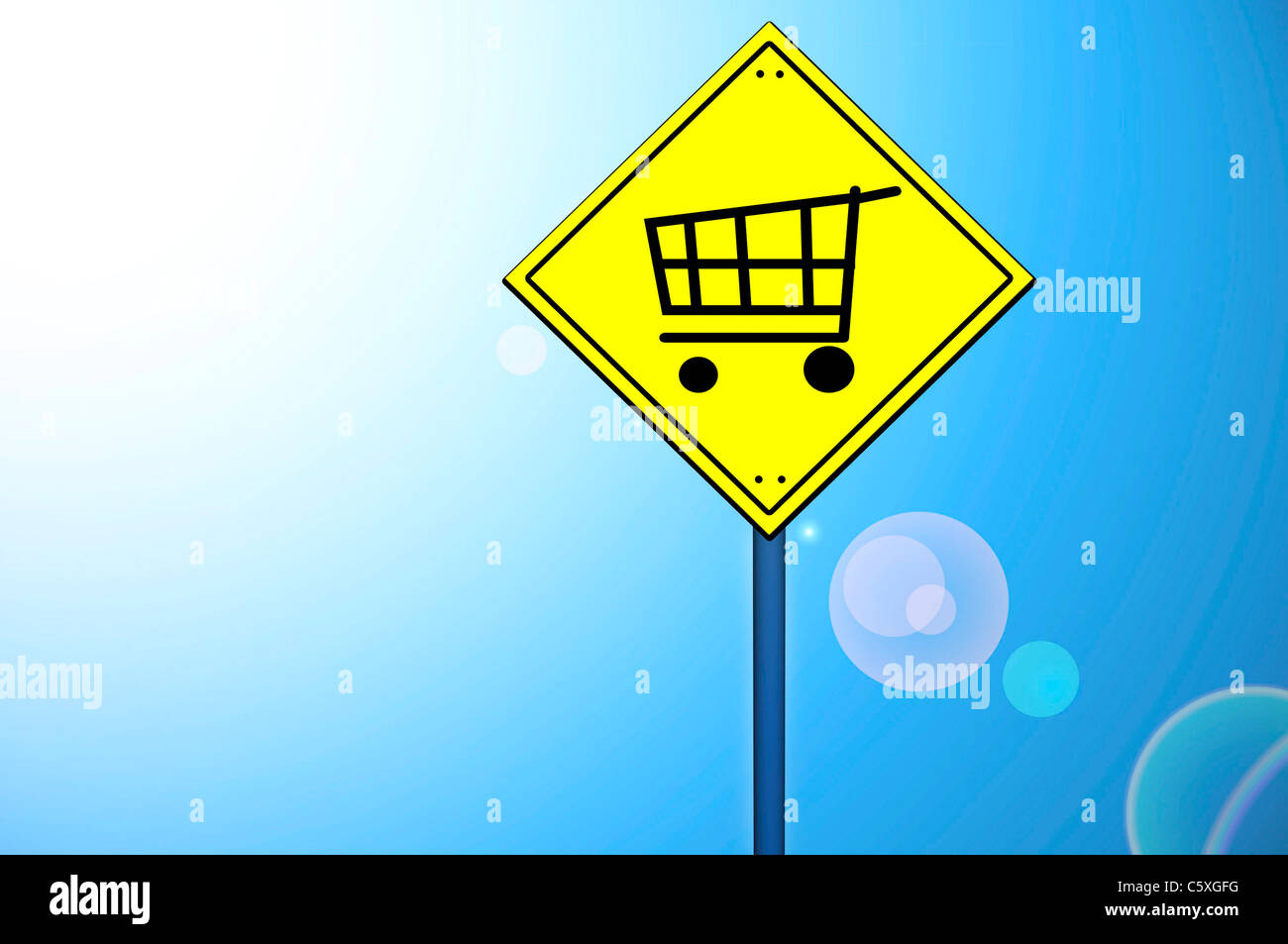 Shopping cart on yellow road sign Stock Photo - Alamy