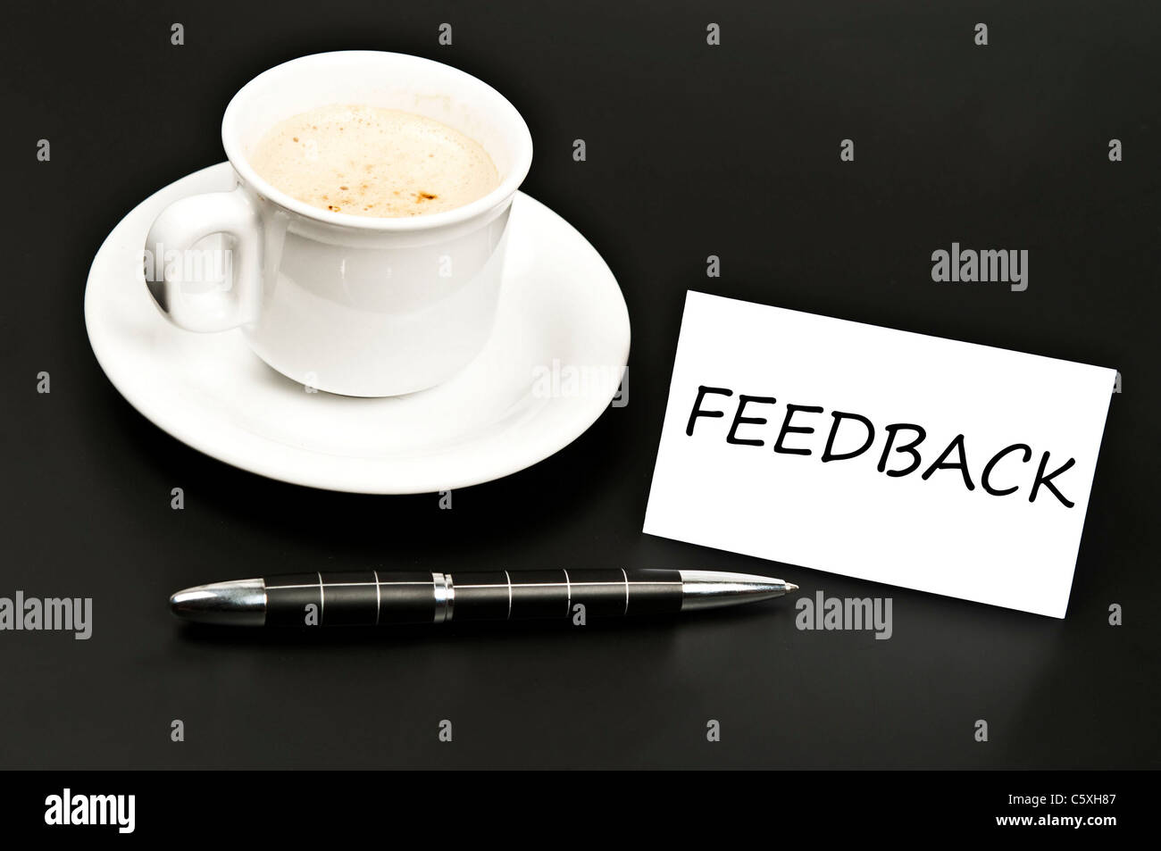 Feedback noted on desk with coffee Stock Photo - Alamy