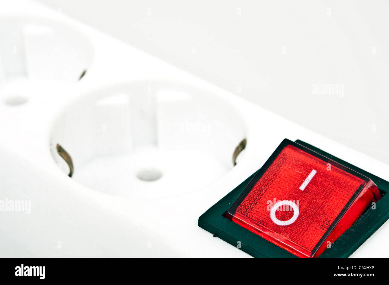 Isolated power outlet with red button Stock Photo - Alamy