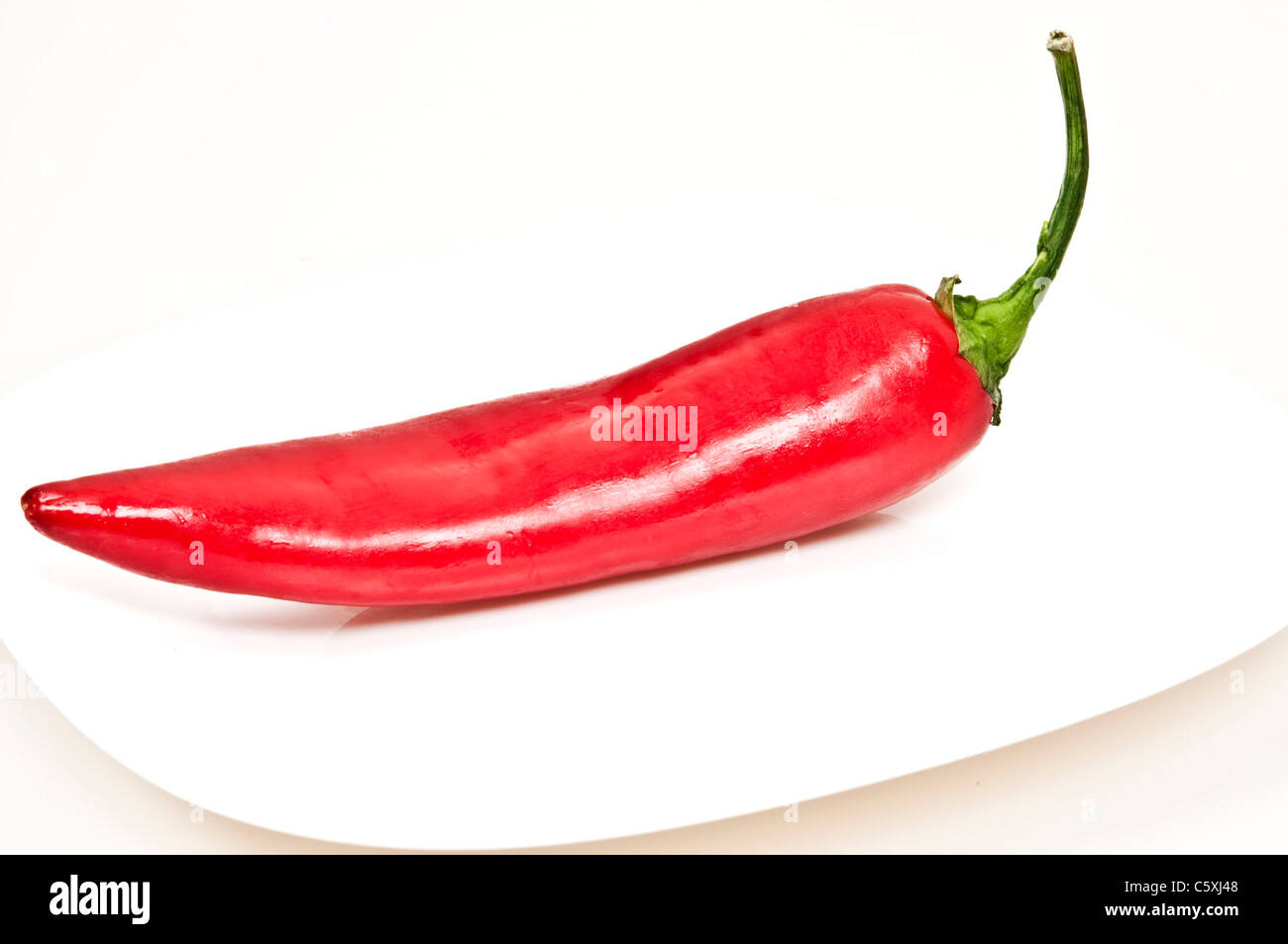 Isolated red pepper on white background Stock Photo - Alamy