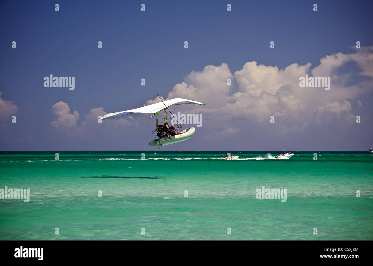 Ocean view of a boat gliding over a cloudy sky Stock Photo - Alamy