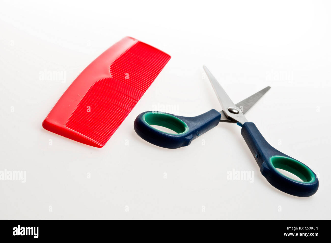 isolated red comb and blue scissors Stock Photo - Alamy
