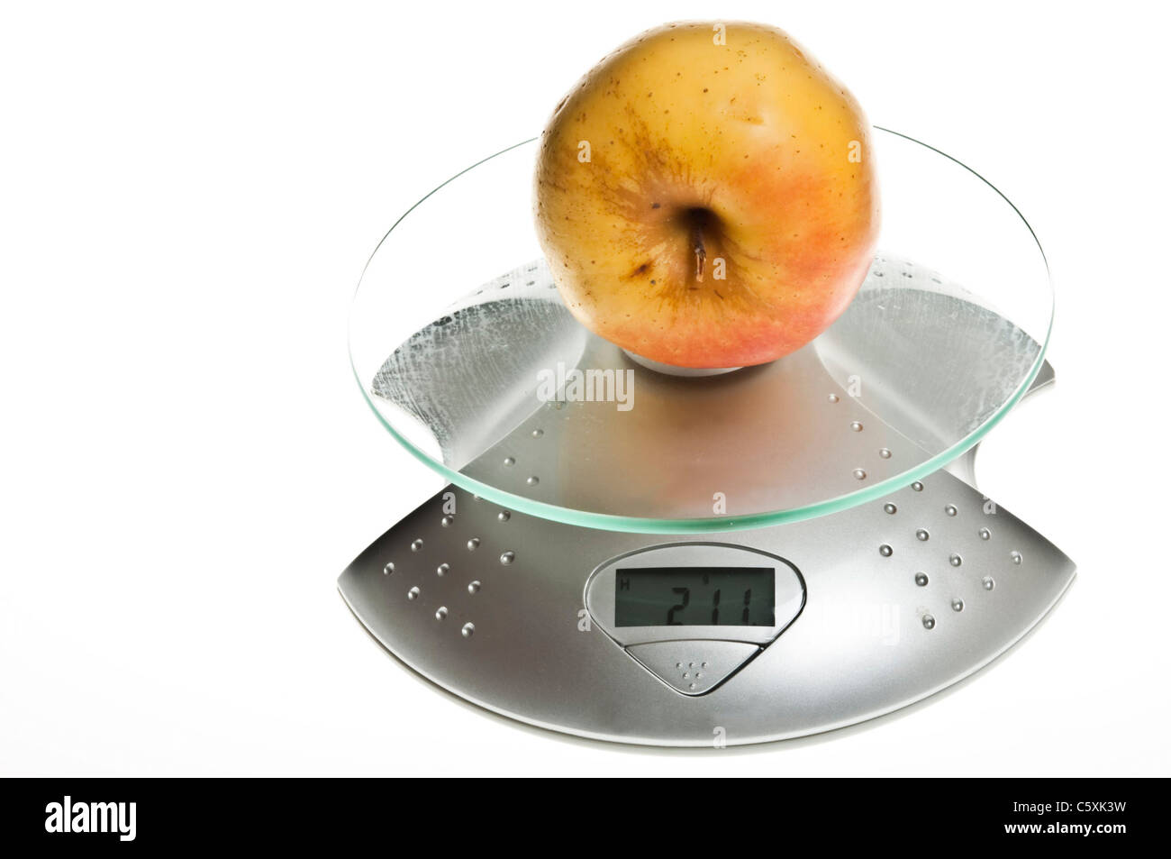Yellow apple isolated on food scale Stock Photo - Alamy