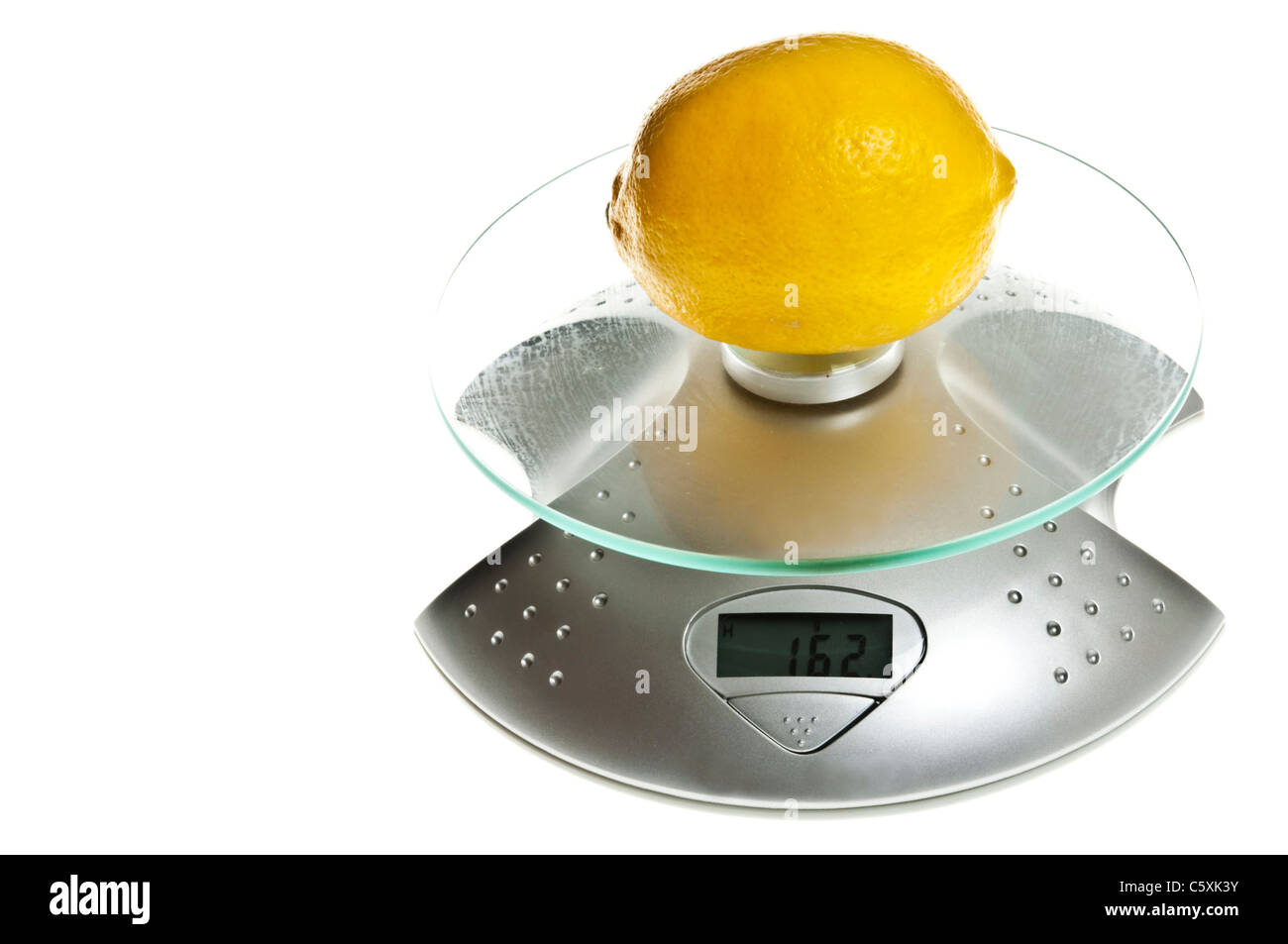 Lemon isolated on food scale Stock Photo - Alamy