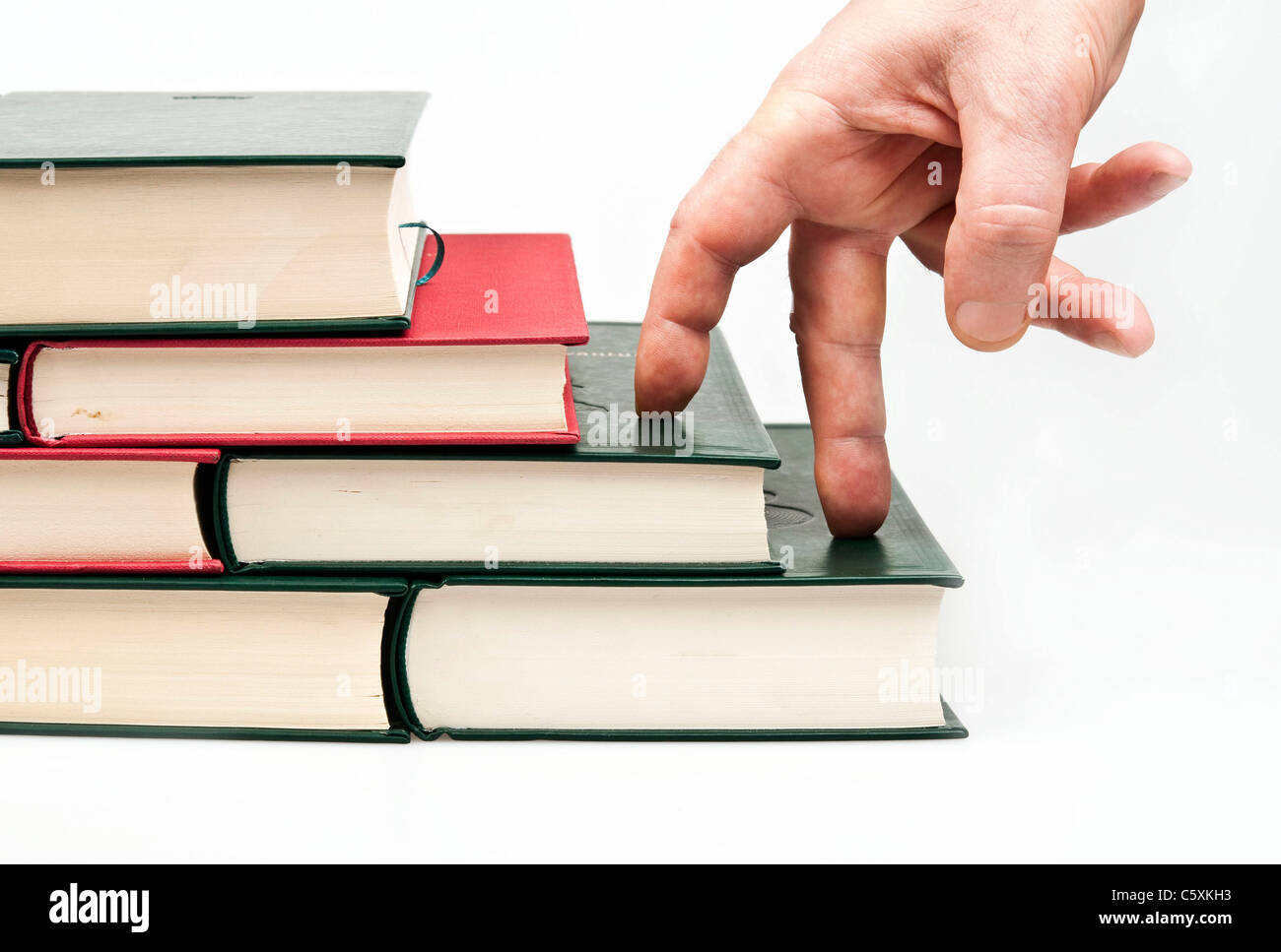 Finger climbing books on white Stock Photo - Alamy