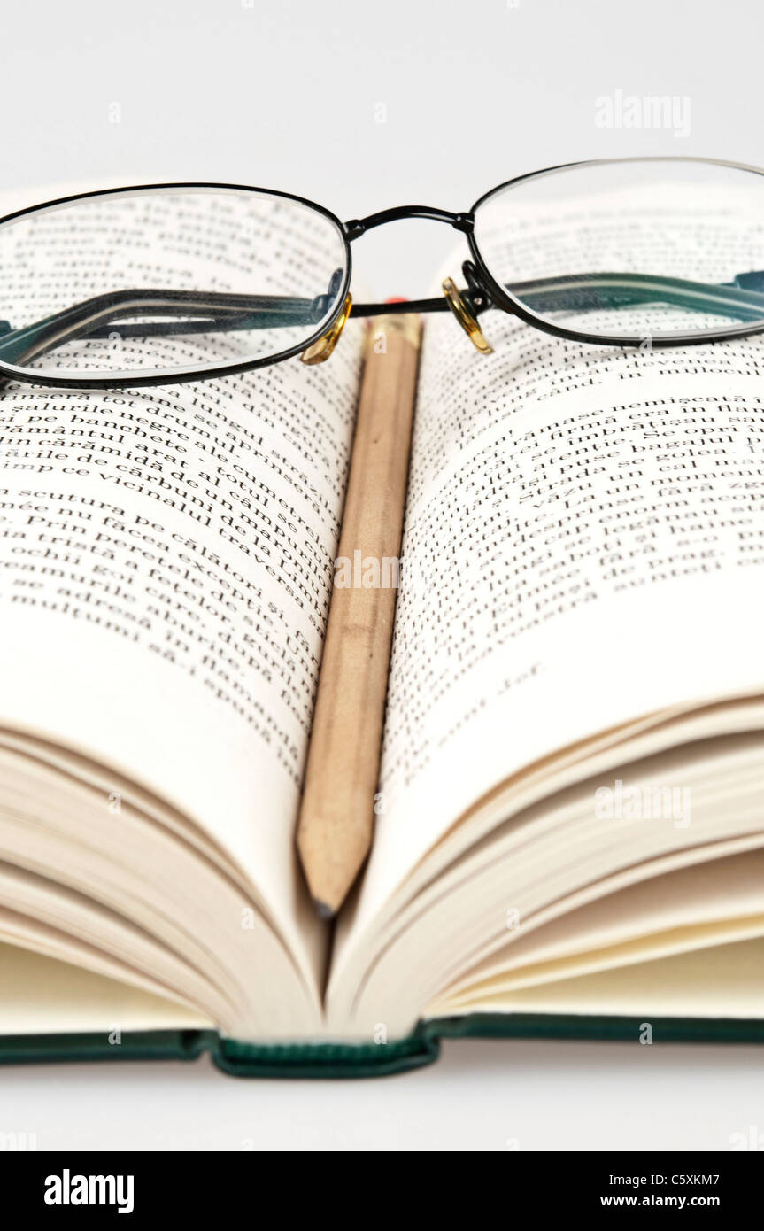 Open book with eye glasses Stock Photo - Alamy