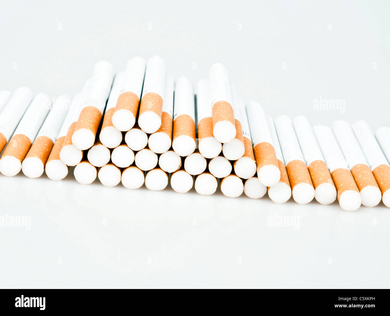 Many cigarettes on white background Stock Photo - Alamy