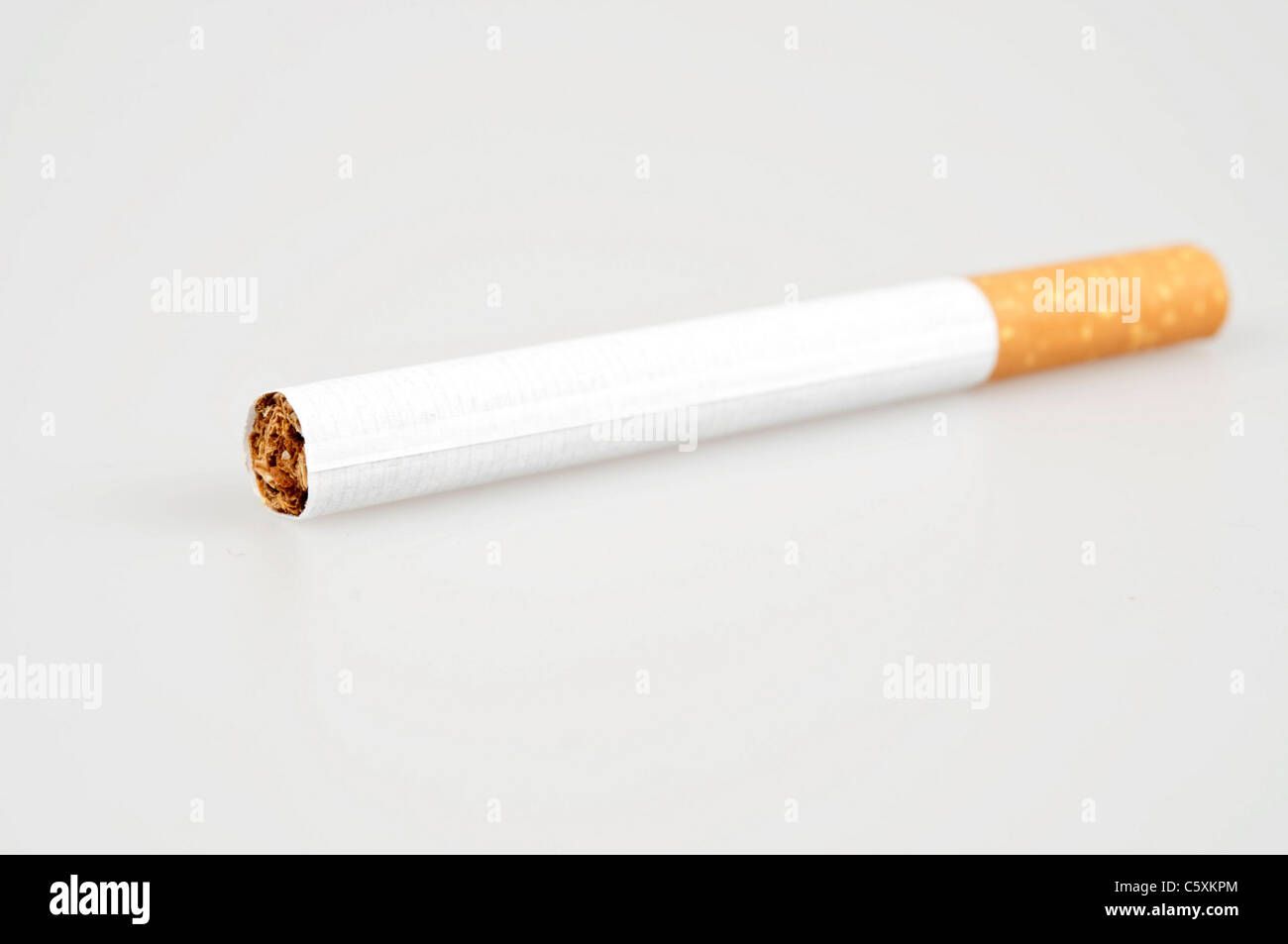 Single cigarette on white background Stock Photo - Alamy