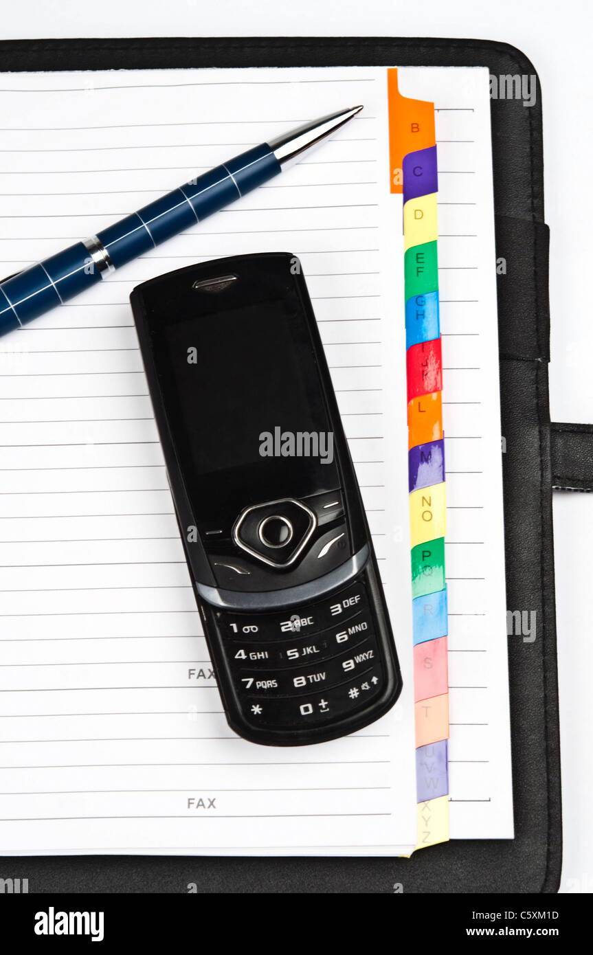Isolated agenda,pen and phone Stock Photo - Alamy