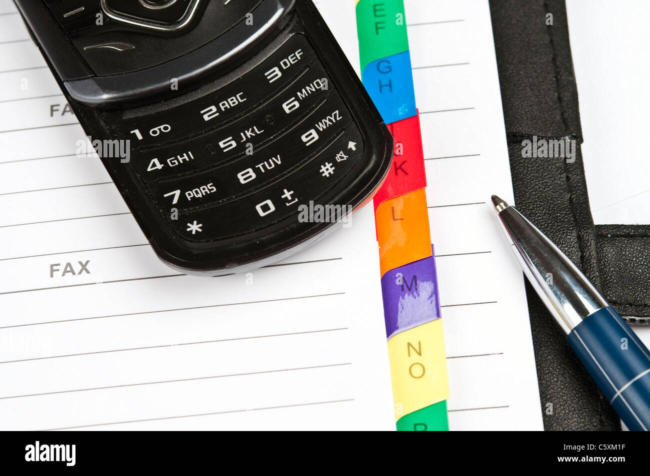 Isolated agenda,pen and phone Stock Photo - Alamy