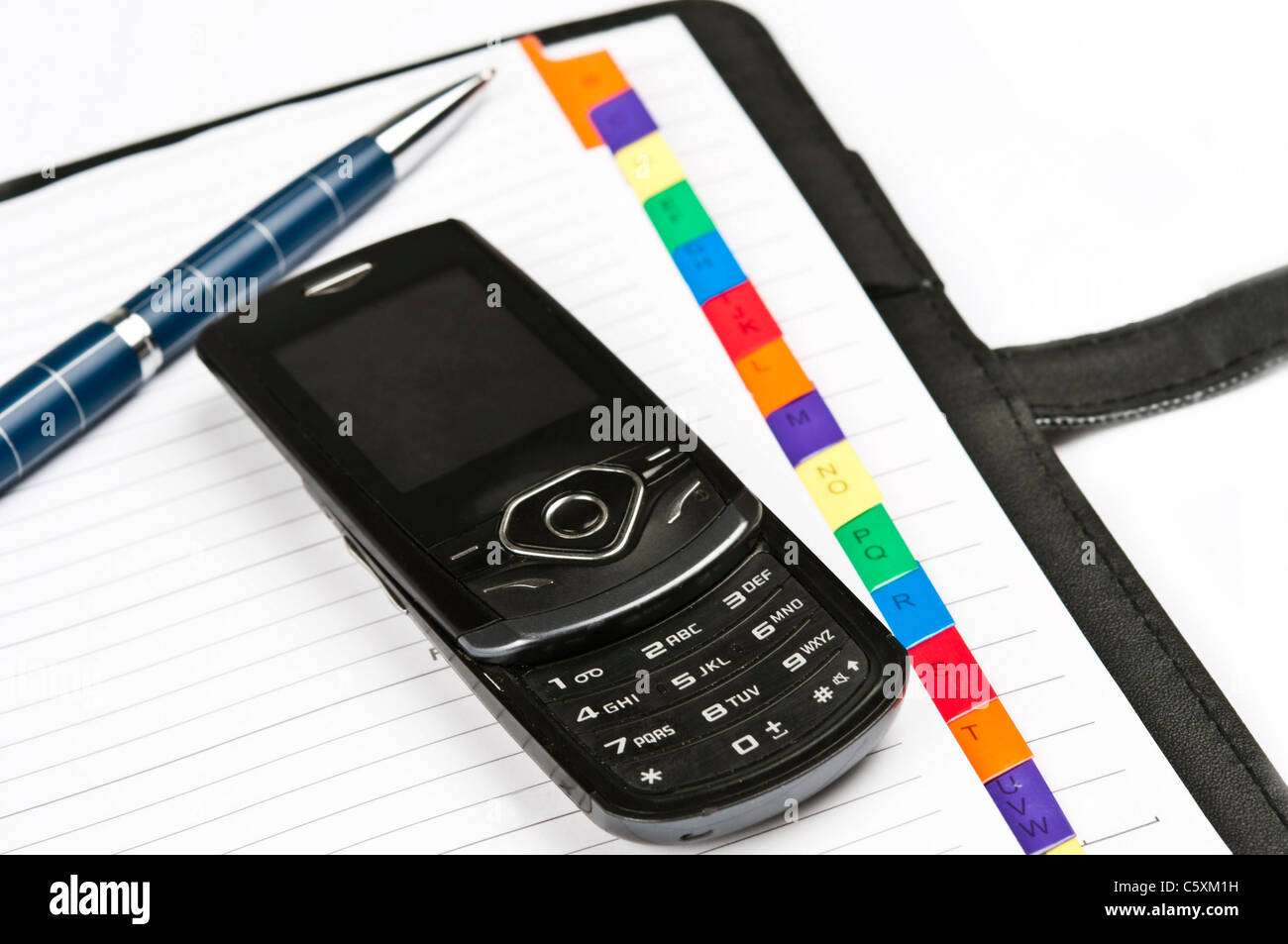 Isolated agenda,pen and phone Stock Photo - Alamy