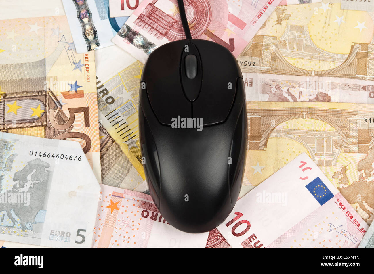Closeup to mouse on euro banknotes Stock Photo - Alamy