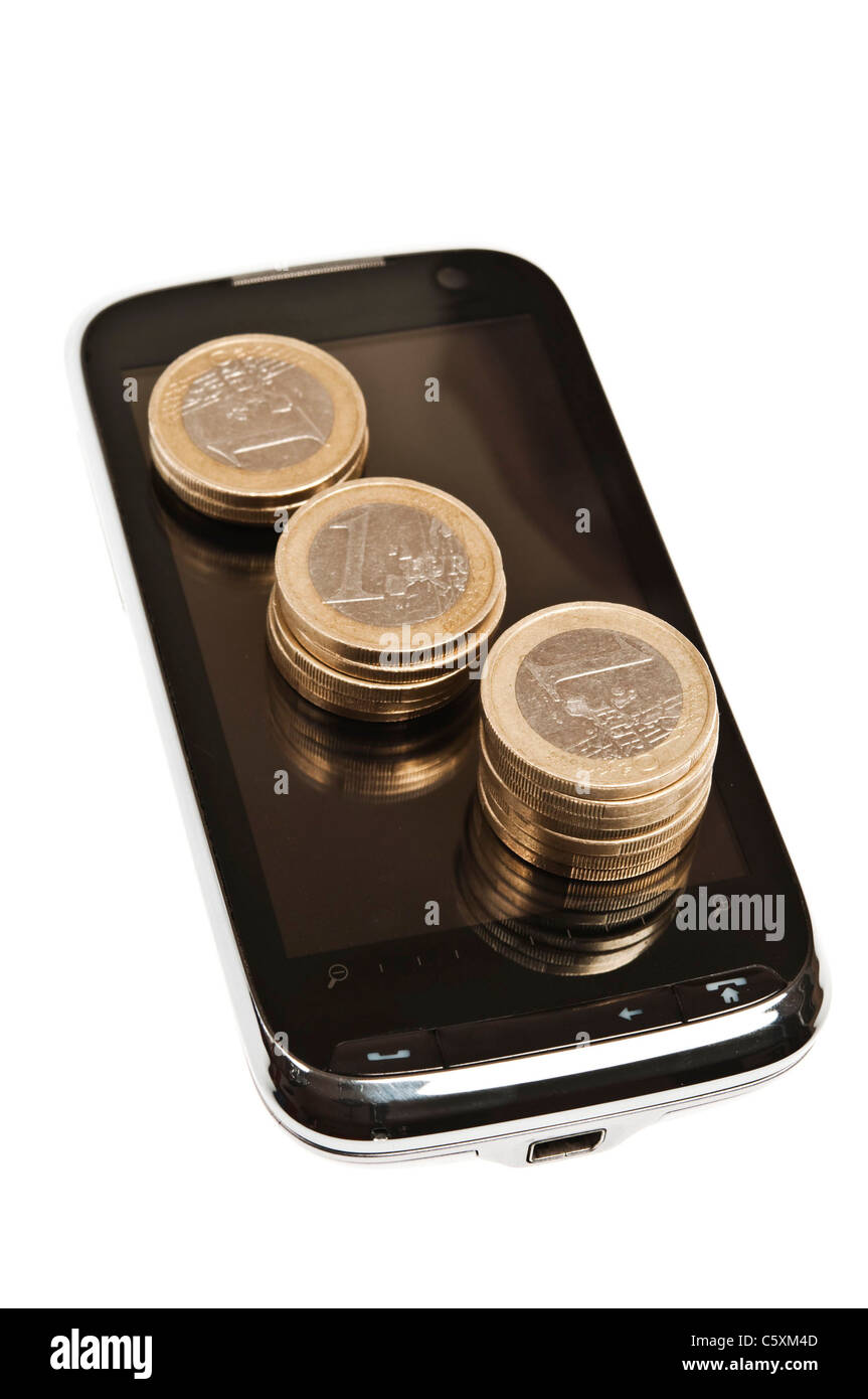 Phone with coins on white Stock Photo - Alamy