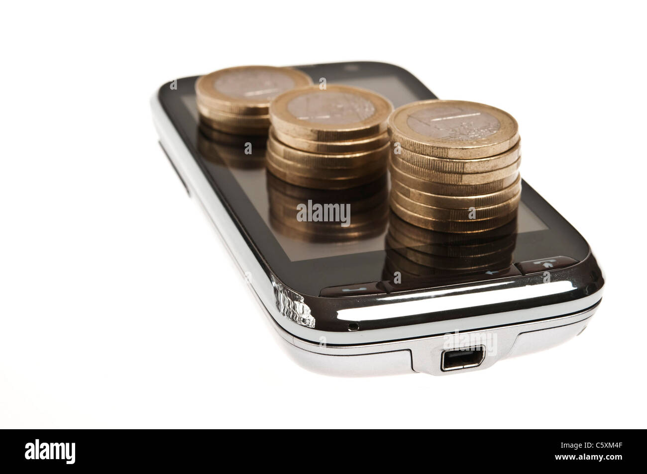 Phone with coins on white Stock Photo - Alamy