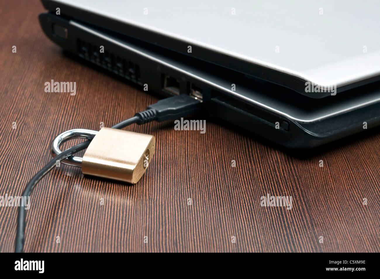 Laptop lock cable hi-res stock photography and images - Alamy