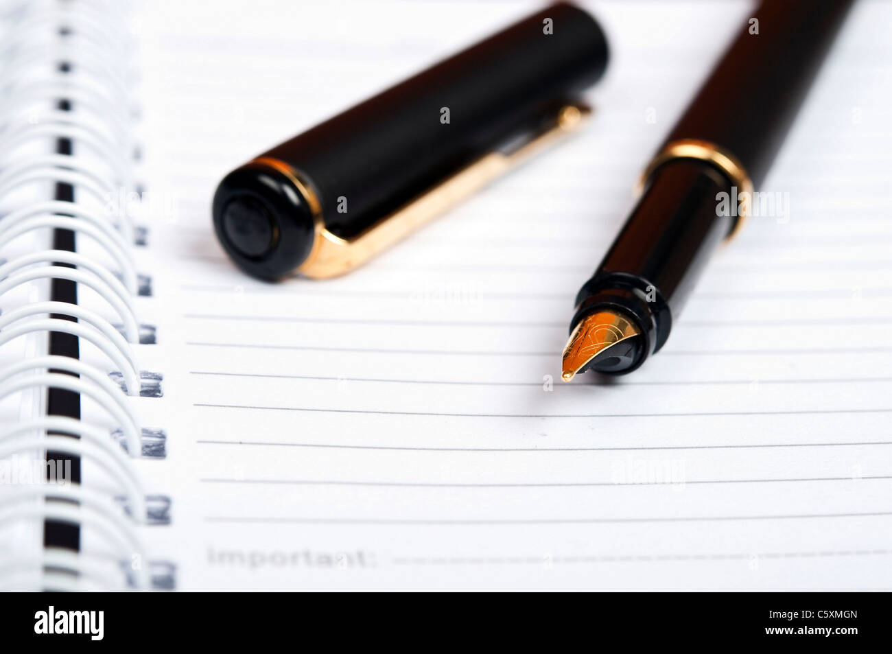 Notebook and luxury black pen Stock Photo - Alamy