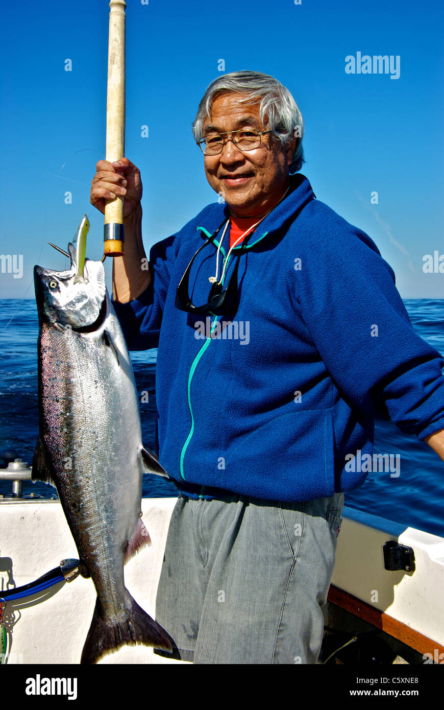 Fisherman angler holding salmon caught hi-res stock photography and ...