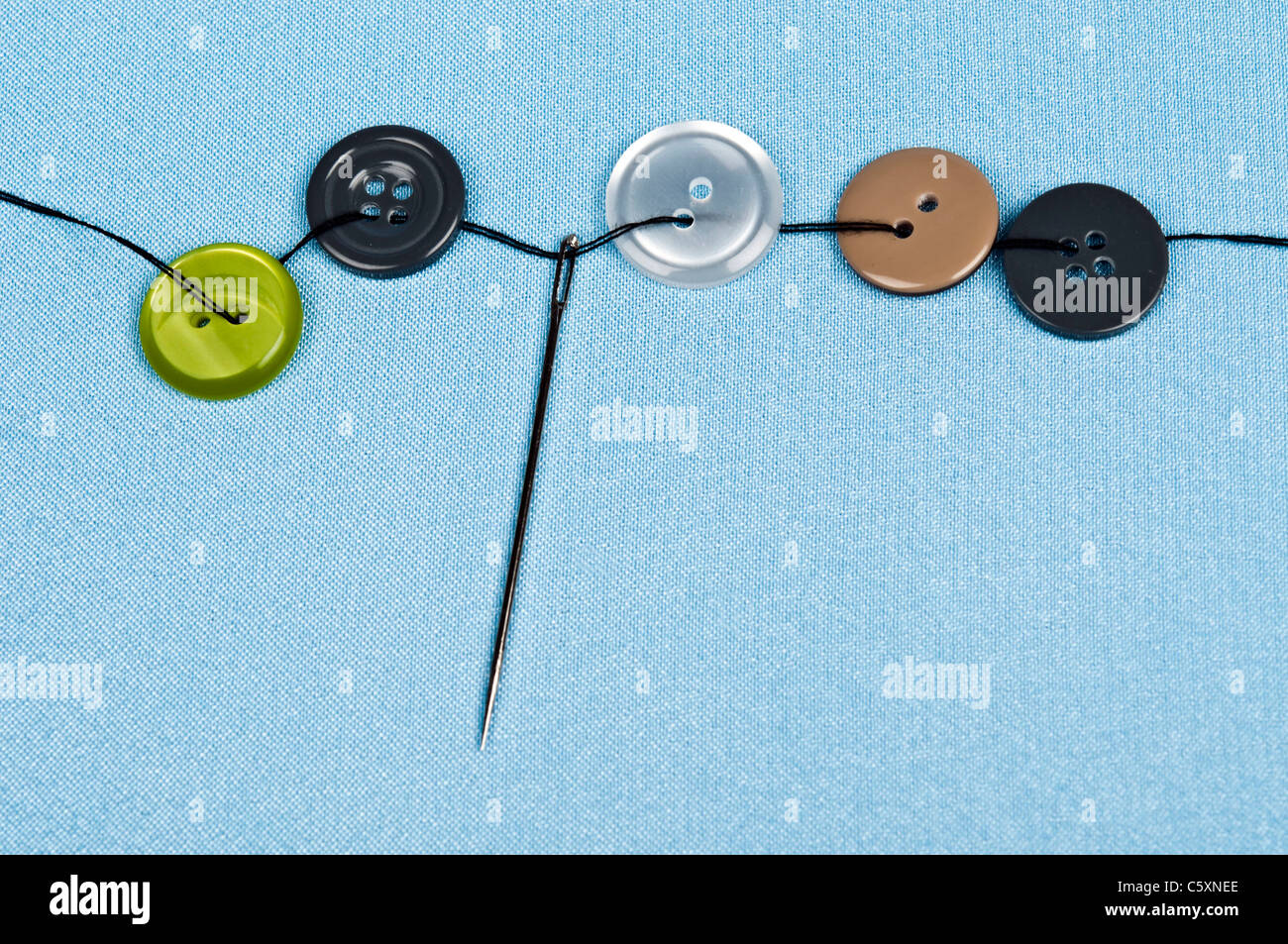 Button and needle hi-res stock photography and images - Alamy