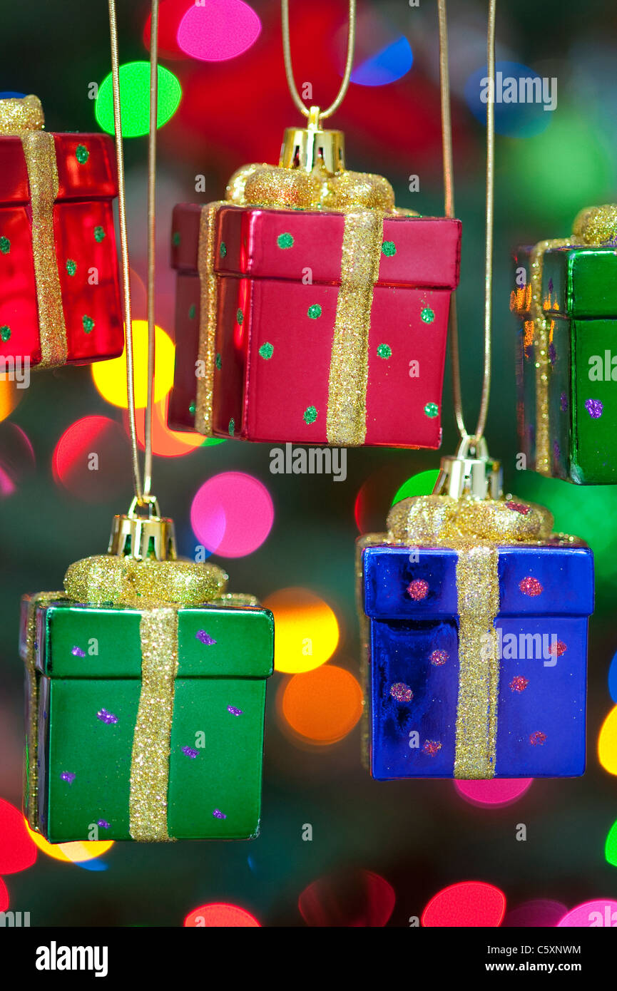 Christmas present ornaments hanging from a Christmas tree with colorful ...