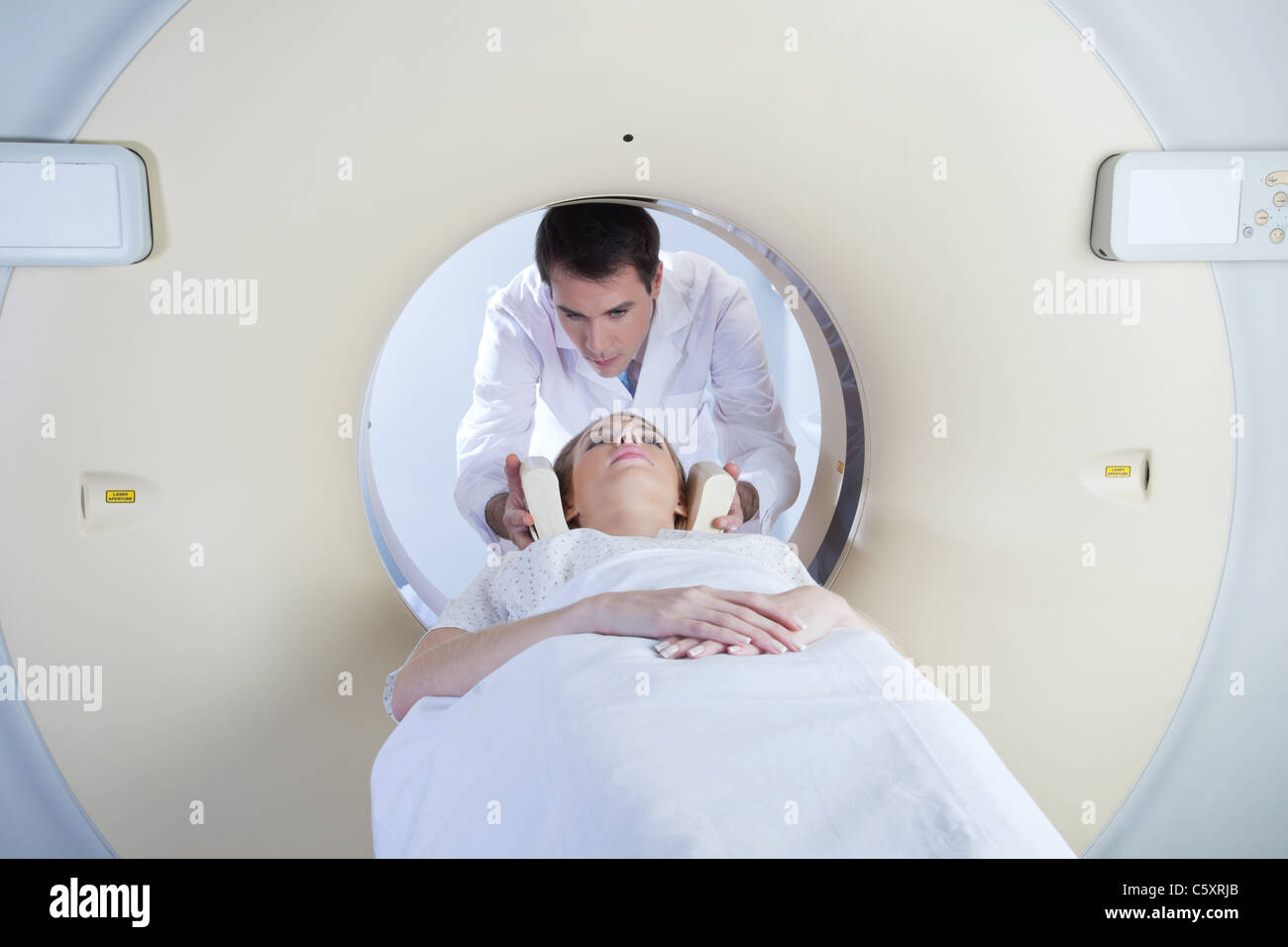 woman in a ct scan with medical professional Stock Photo - Alamy