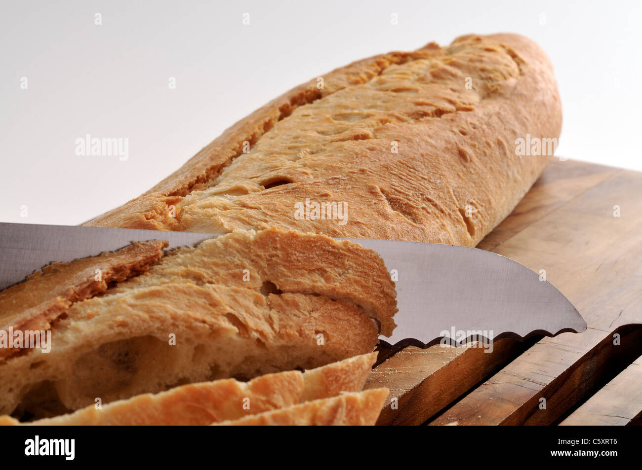 Cutting slices from bread loaf Stock Photo - Alamy