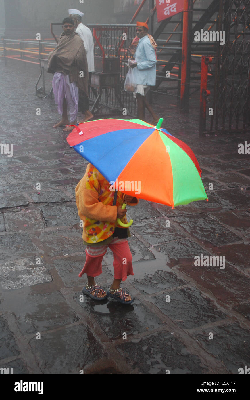 Too small umbrella rain hi-res stock photography and images - Alamy