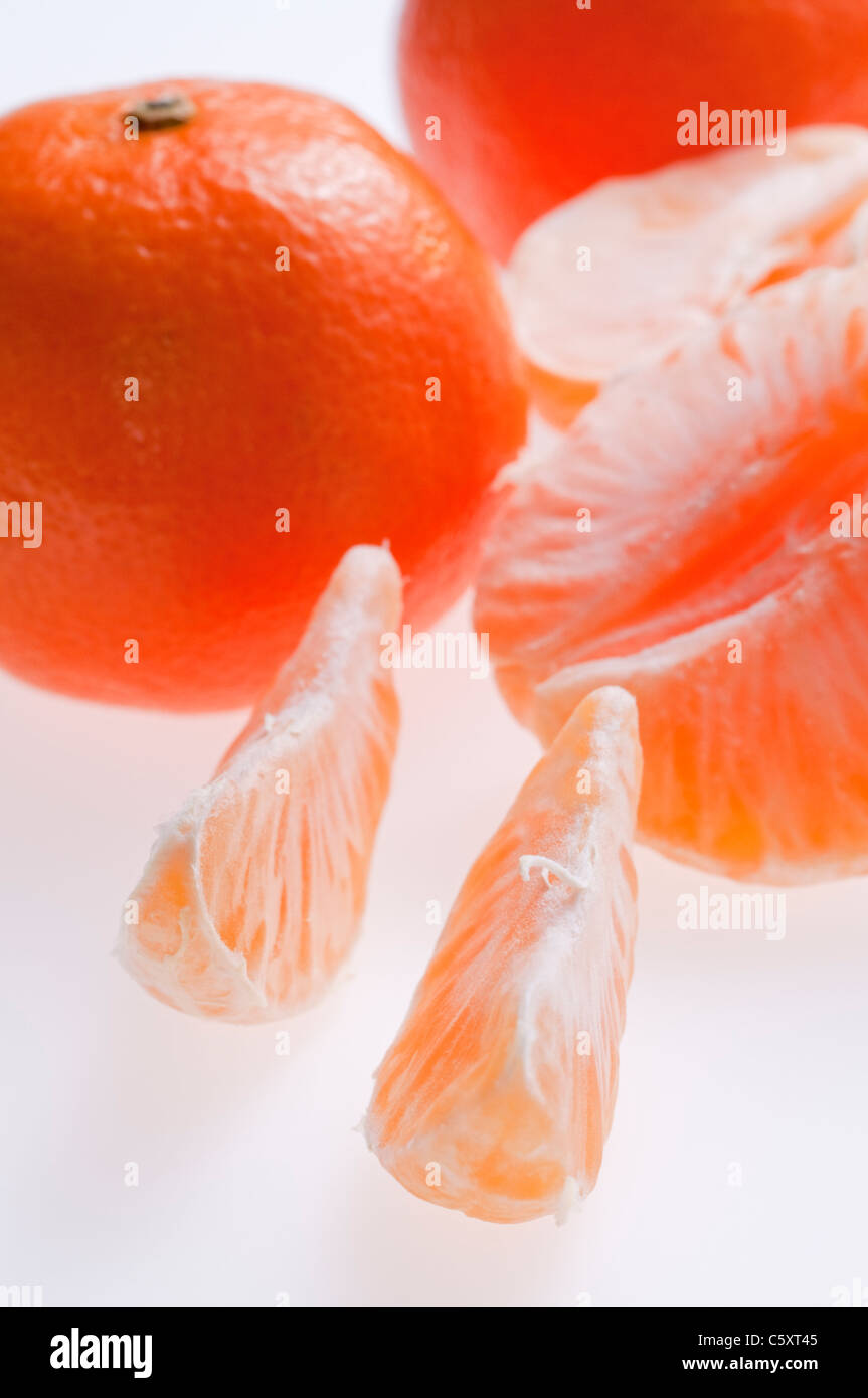 Orange segments on a white background Stock Photo - Alamy